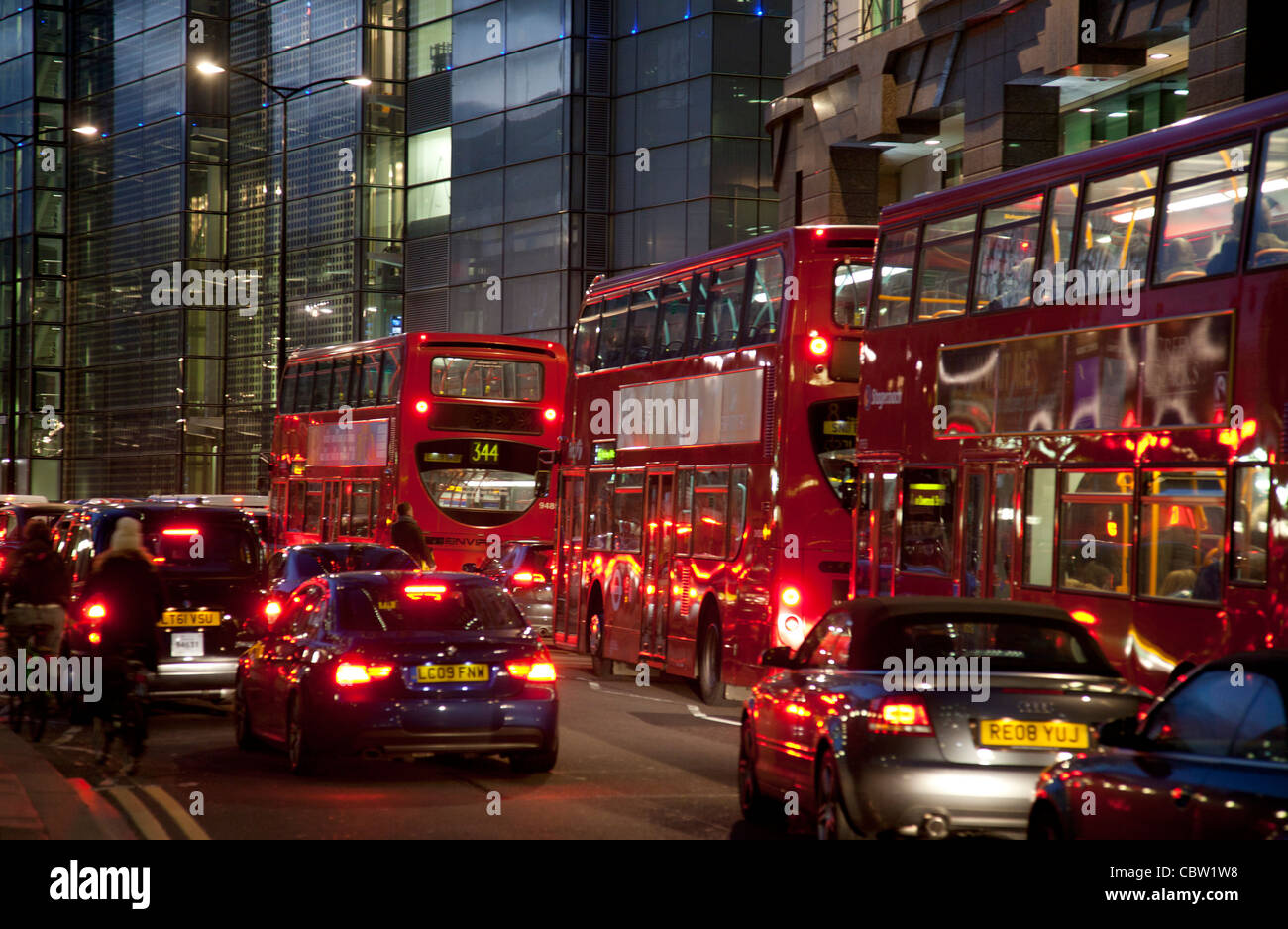 Red lights as buses and cars move along Camomile Street in the City of ...