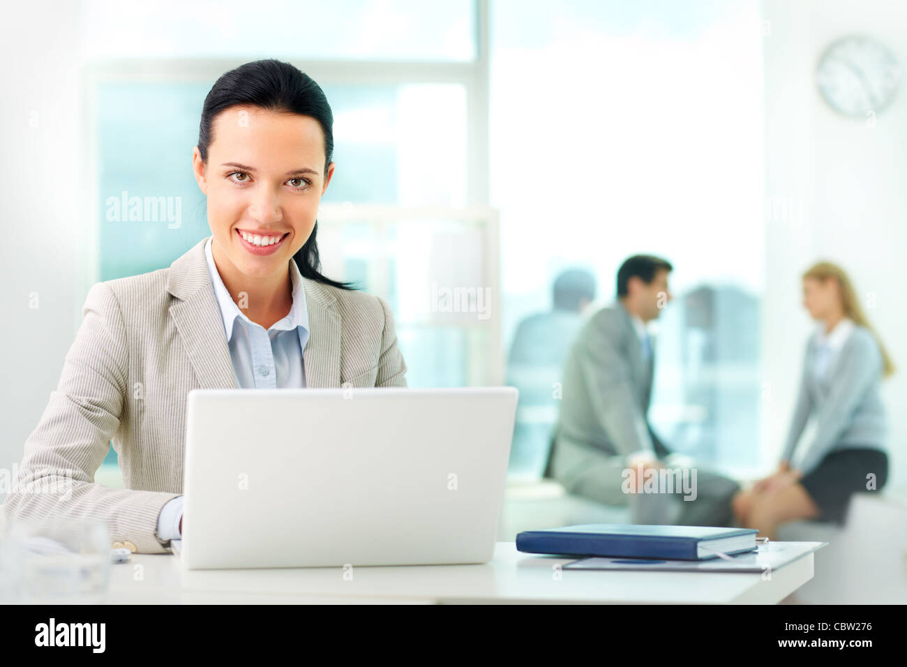 Portrait of pretty secretary looking at camera while working Stock ...