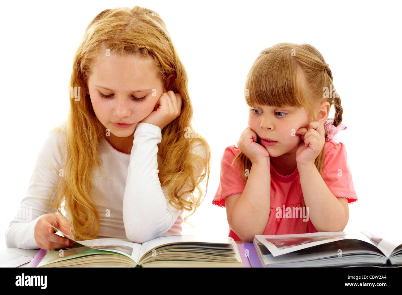 Portrait of cute girls reading interesting books Stock Photo - Alamy