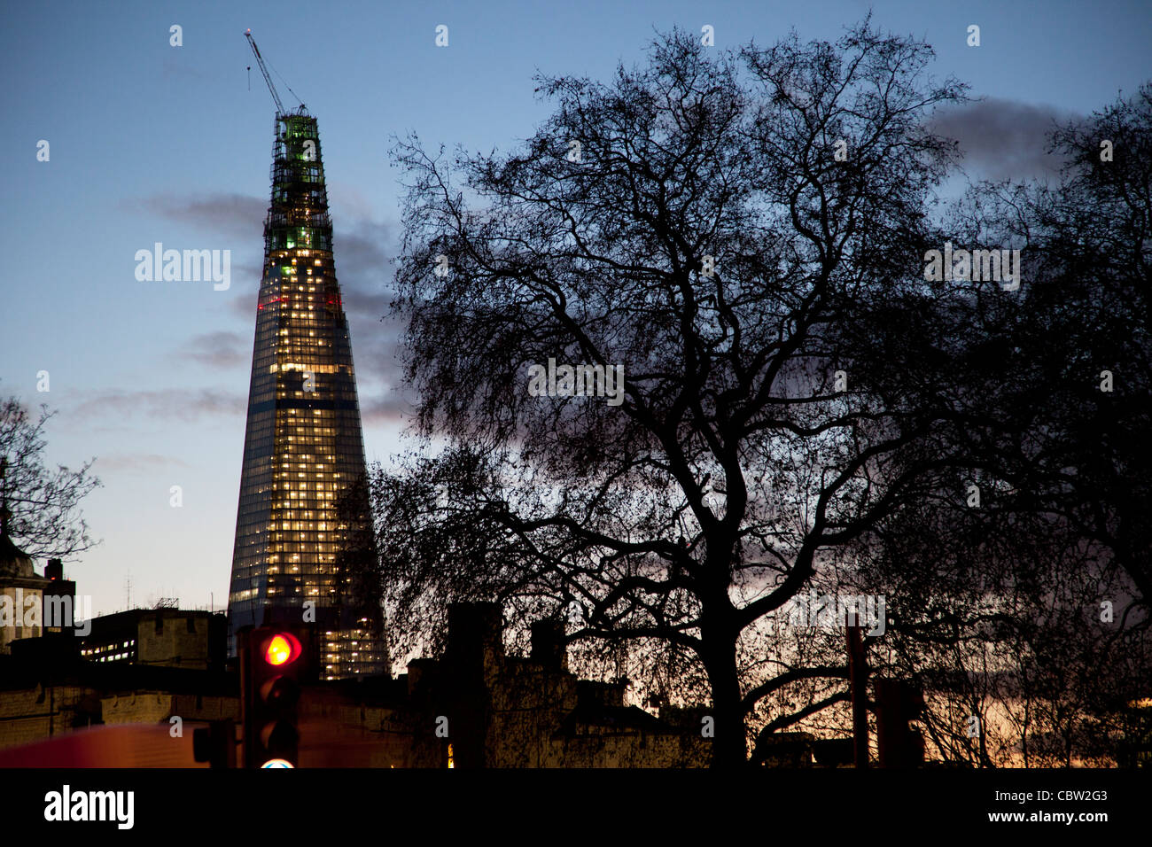 The Shard, under construction at night sits behind the silhouette of a ...