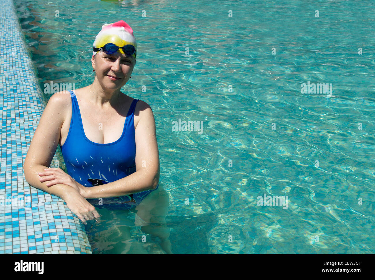 Smiling swimmer relaxing on the border of the swimming pool Stock Photo ...