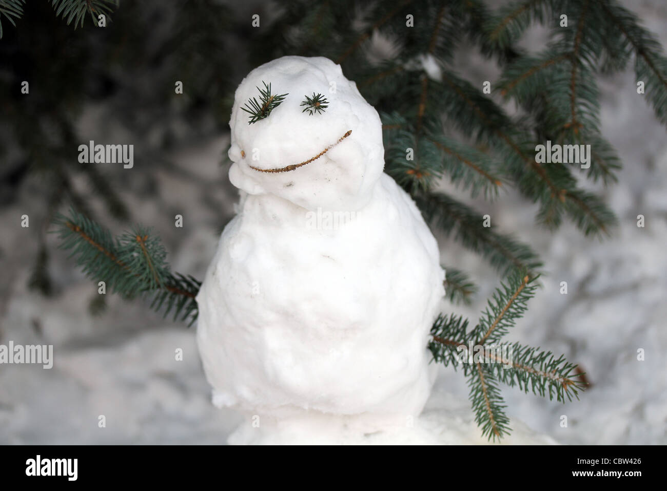 Snowman under the tree Stock Photo - Alamy