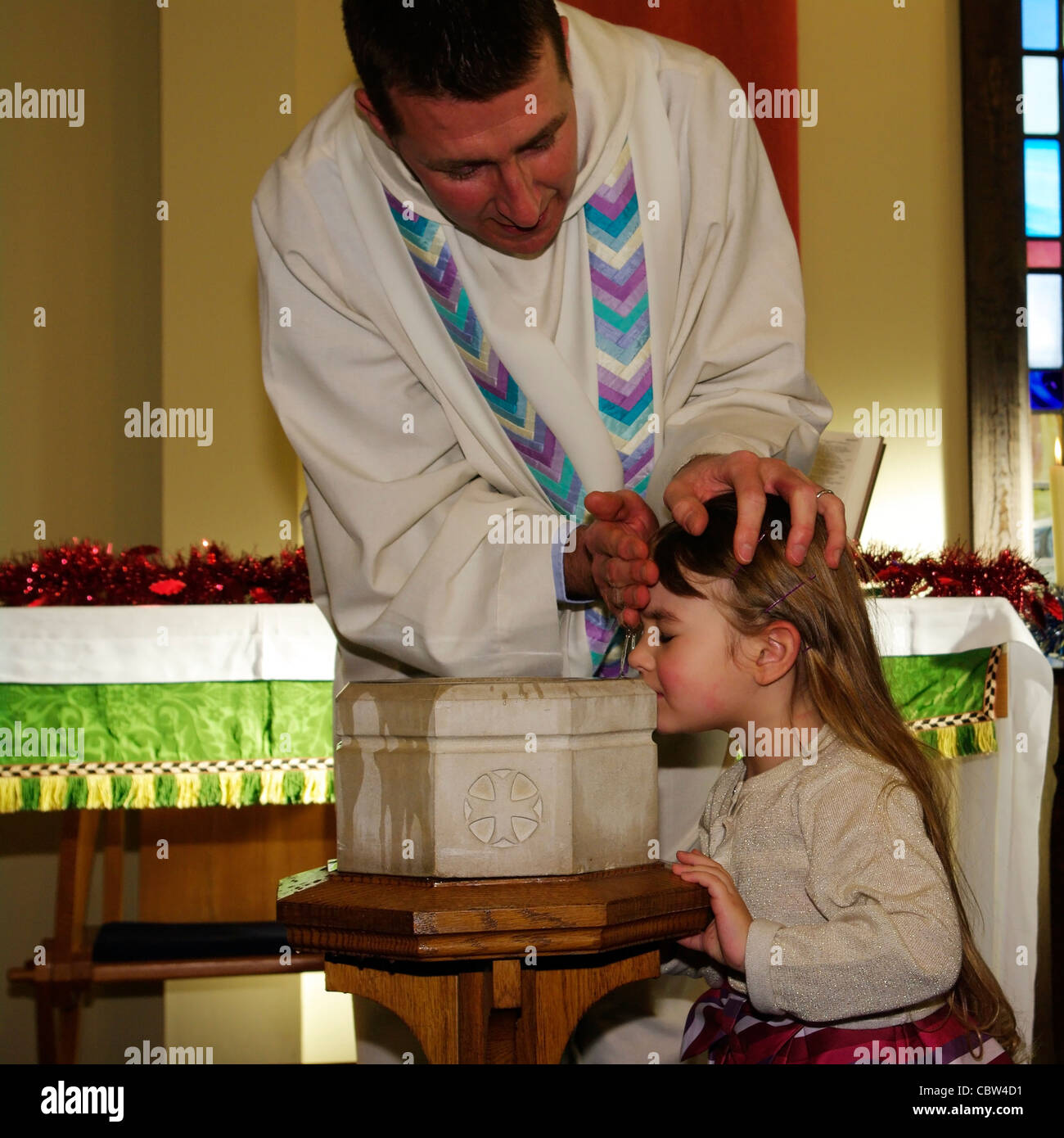 Priest Vicar Baptising Baptizing A young girl Child Christening ...
