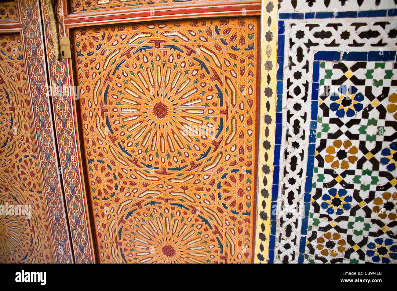 Ornate carved wooden doors to a mosque with mosaic tile work in the ...