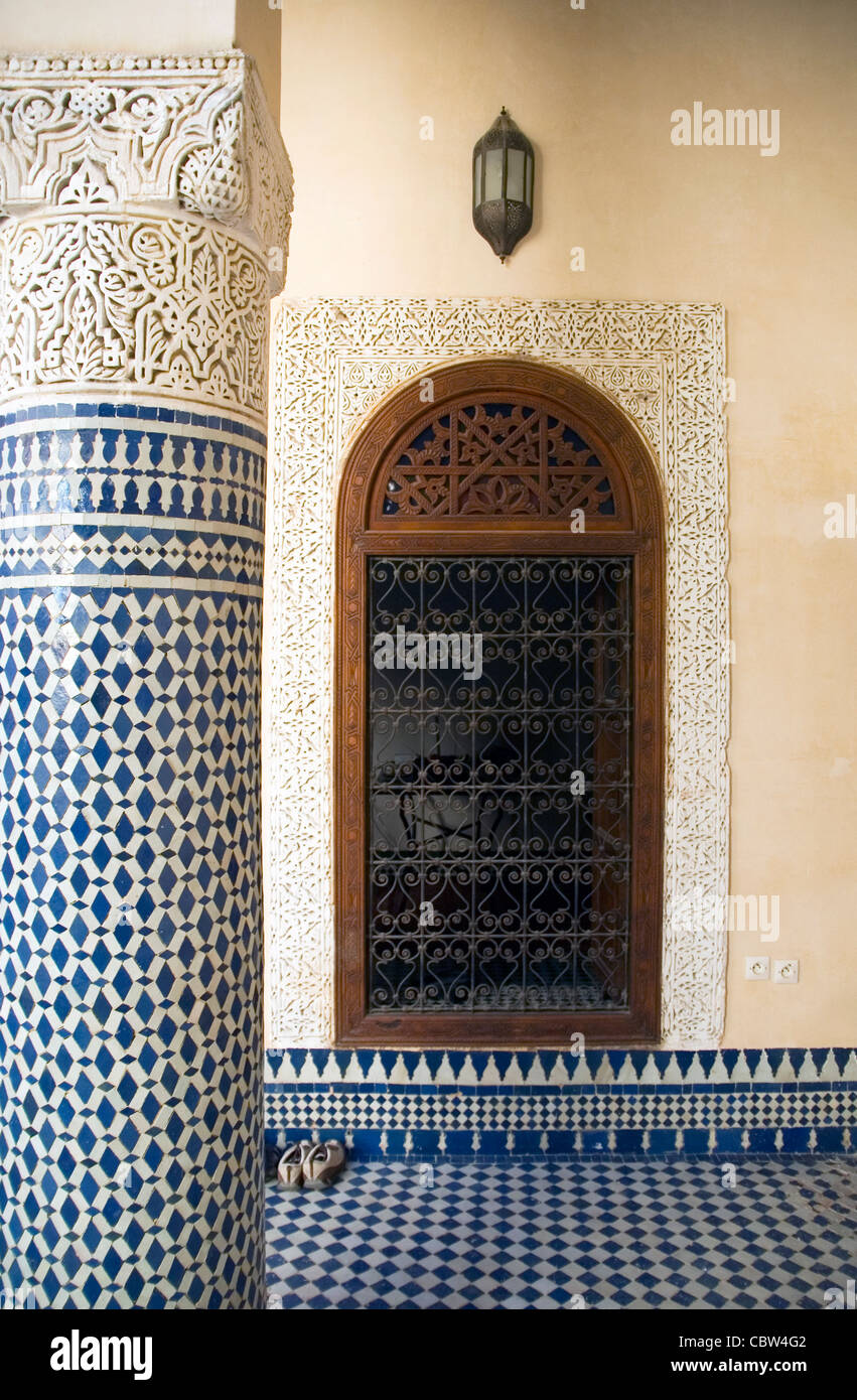 Traditional ornate plaster work and mosaic tiles with carved wooden ...