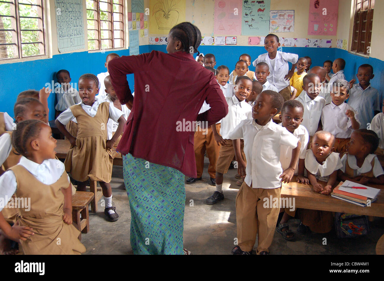 Happy children in the pews of a primary school in the third world ...