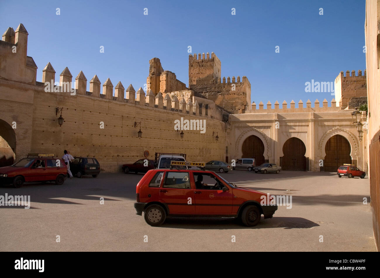 Red taxi at the old walled city and gates of Fez in northern Morocco ...