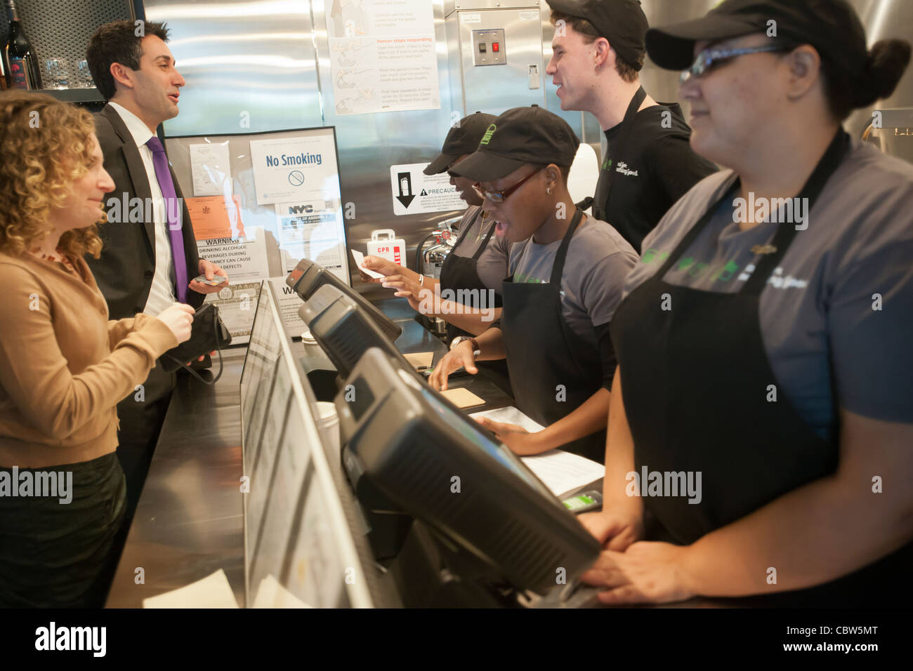 Employees hustle to fill and serve orders at the grand opening of the ...