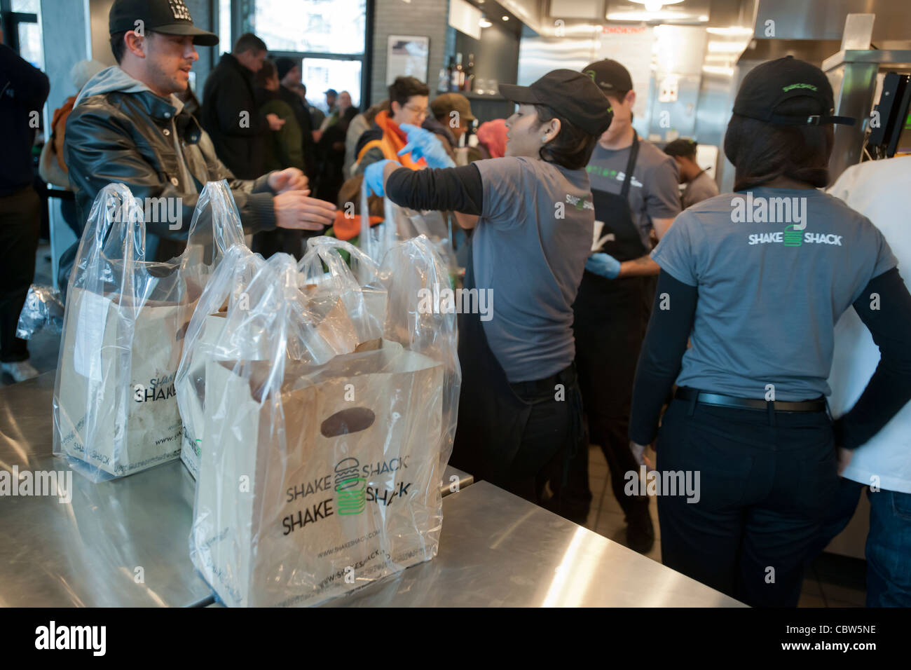 Employees hustle to fill and serve orders at the grand opening of the ...