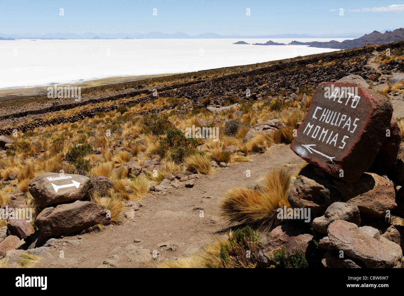 A sign for the caves with mummies at Tunupa above the Salar de Uyuni ...