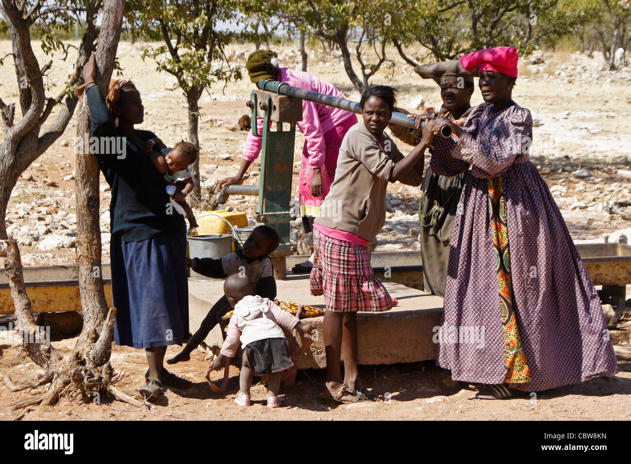 Women by water pump hi-res stock photography and images - Alamy