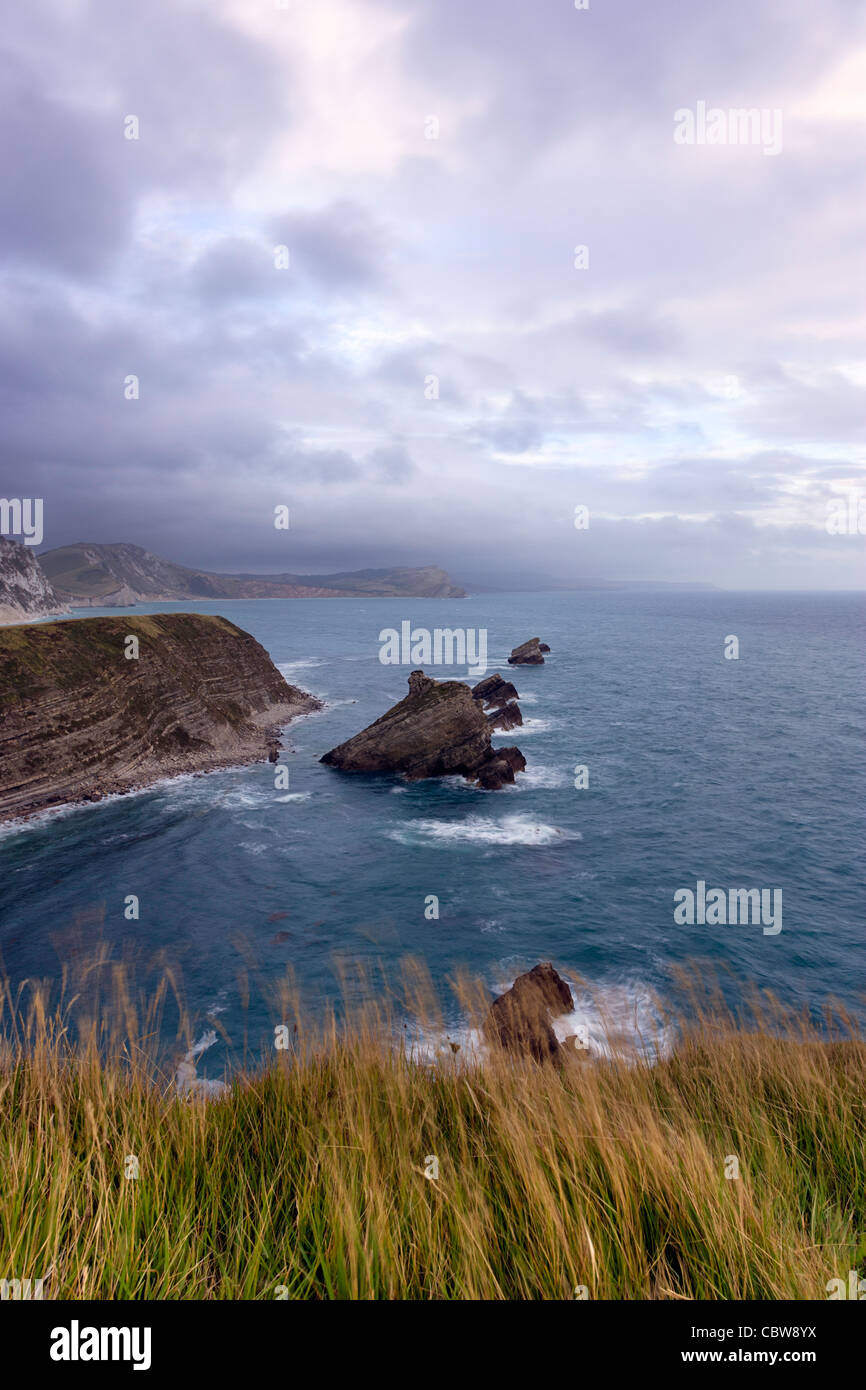 Dramatic Sky over Mupe Bay with rock out crops in the ocean and blurred ...