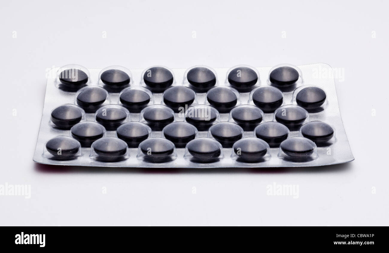 Black Pills in blister on gray Stock Photo - Alamy