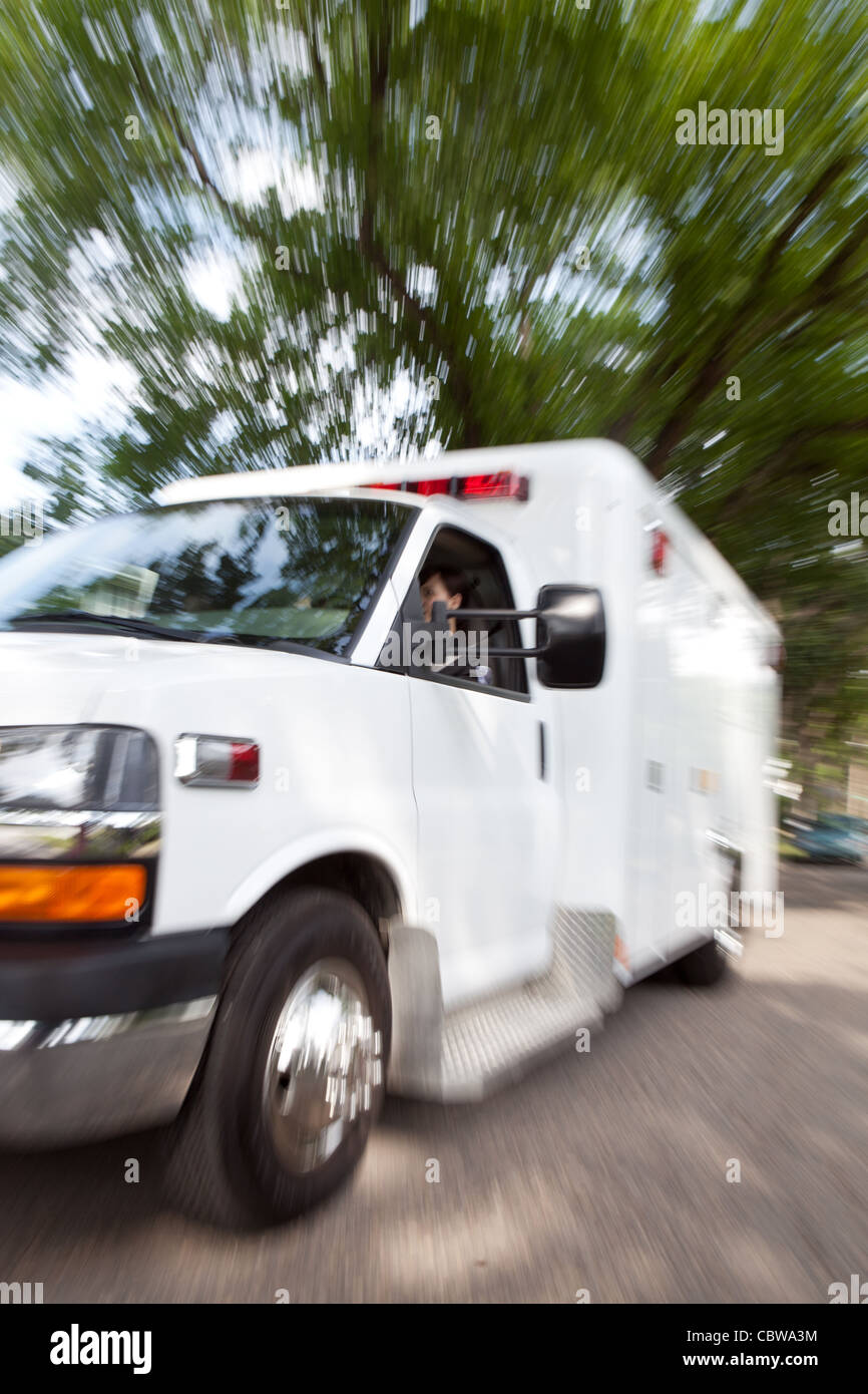 Motion blur of ambulance speeding with female paramedic driving Stock ...