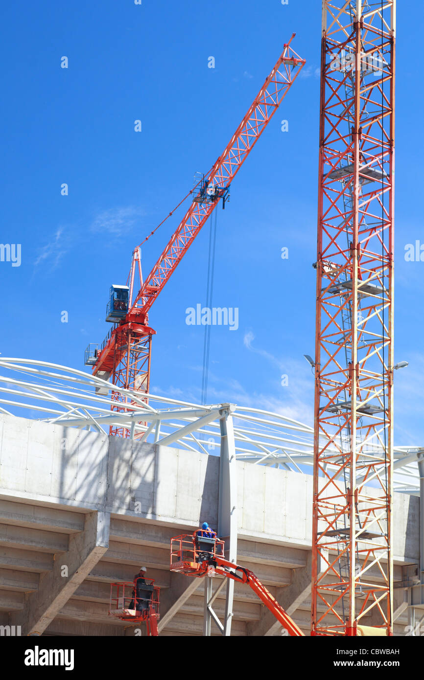 The crane elevating against the blue sky Stock Photo - Alamy