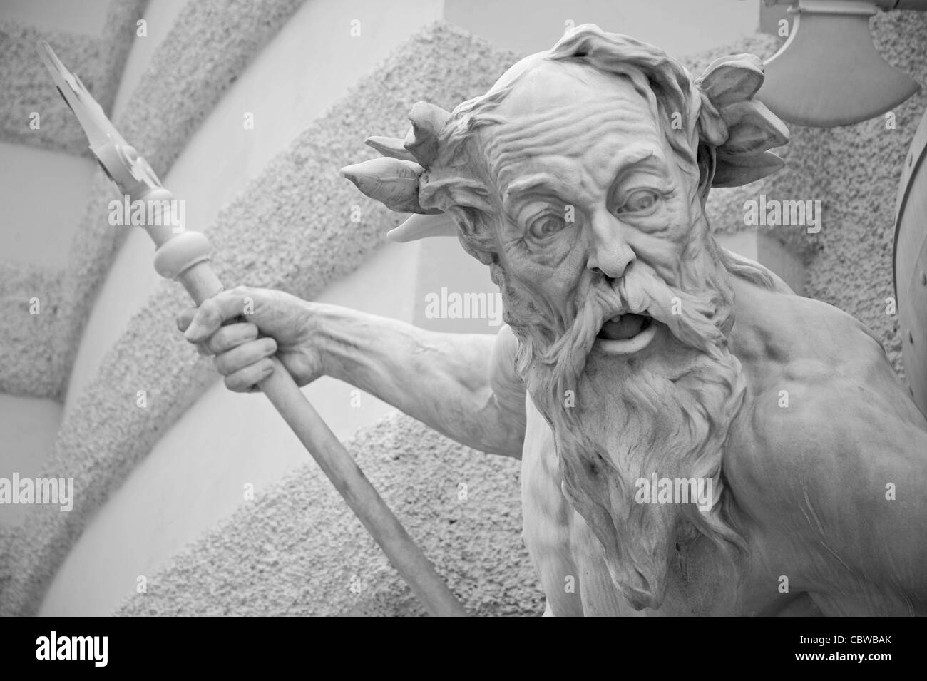 white stone sculpture of old man with long beard and mustache armed ...