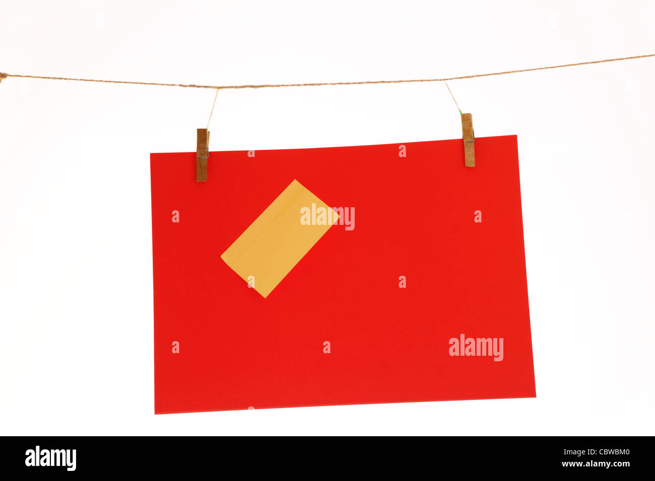 red blank paper sheet on a clothes line. Isolated on white background ...