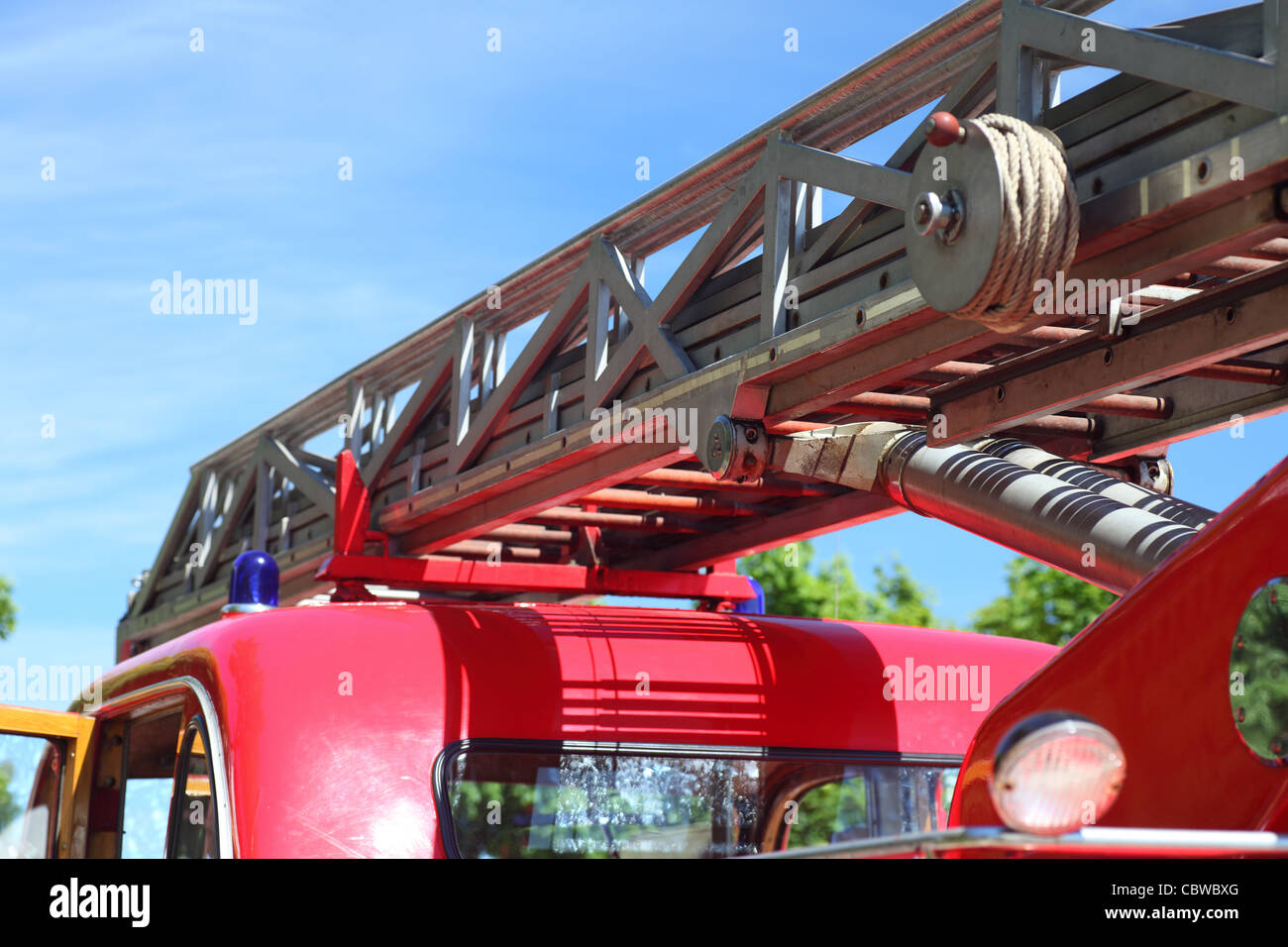 Ladder of a fire truck on the blue sky, emergency light on firetruck ...