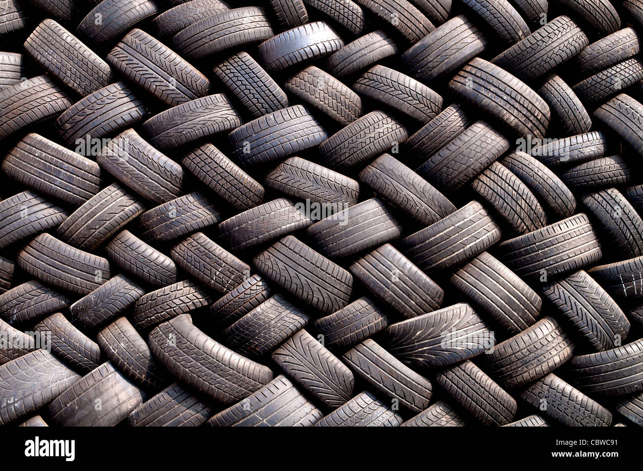 Stack of old tires in a garage Stock Photo - Alamy