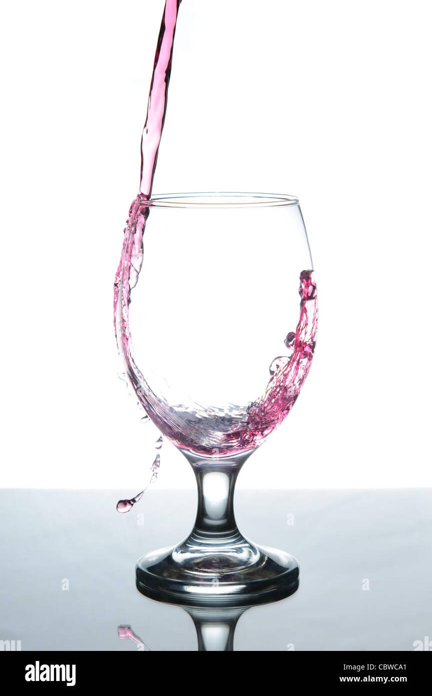 Colored water poured into a water glass Stock Photo - Alamy