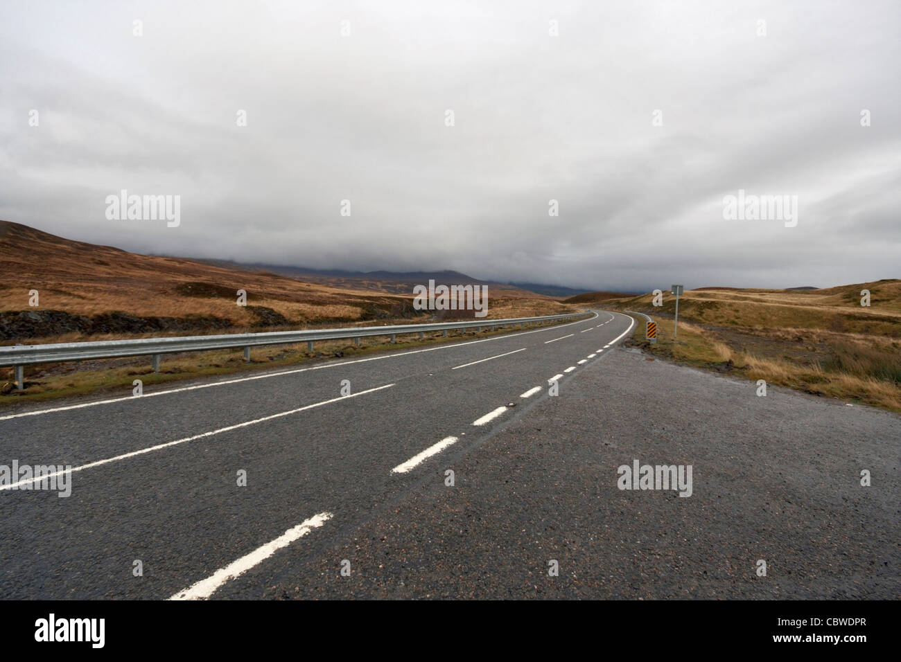 roadside scenery near Ullapool in Scotland with dramatic sky at autumn ...