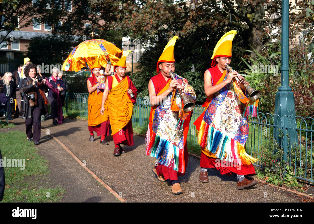 Tibetan monks chant and play musical instruments before they begin to ...