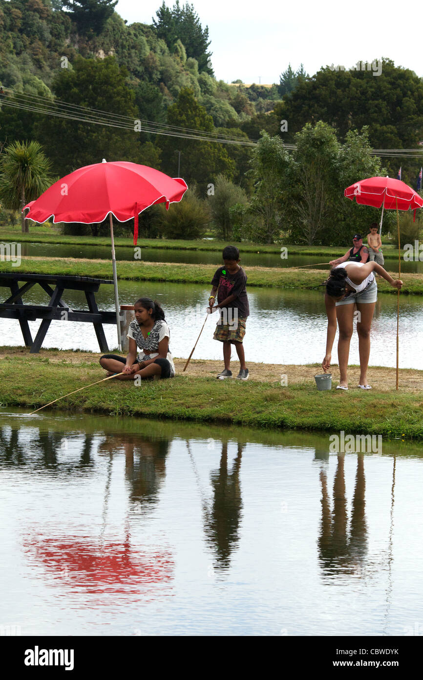 Youngsters fishing for prawns at the Huka Prawn Park, Taupo, New ...