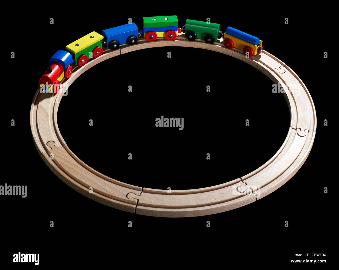 studio photography of a colorful wooden toy train on wooden tracks in ...
