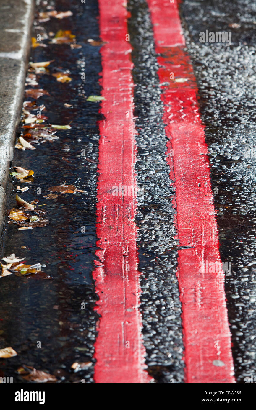 Double red lines on a no stopping route in London, UK Stock Photo - Alamy