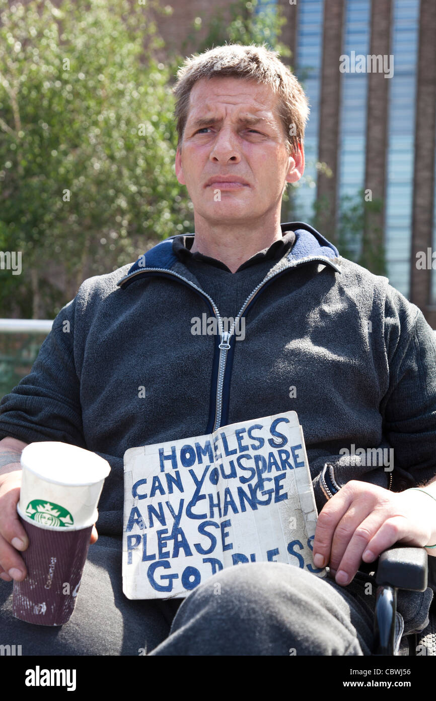 Homeless amputee in a wheelchair begging for money Stock Photo - Alamy