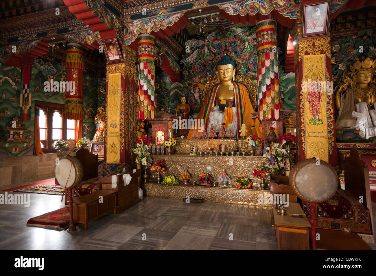 India, Bihar, Bodhgaya, Bhutanese Temple interior, gilded Buddha and ...