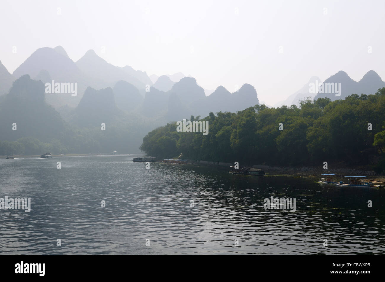 Tour boats on the Li River Guangxi China with karst dome mountains in ...