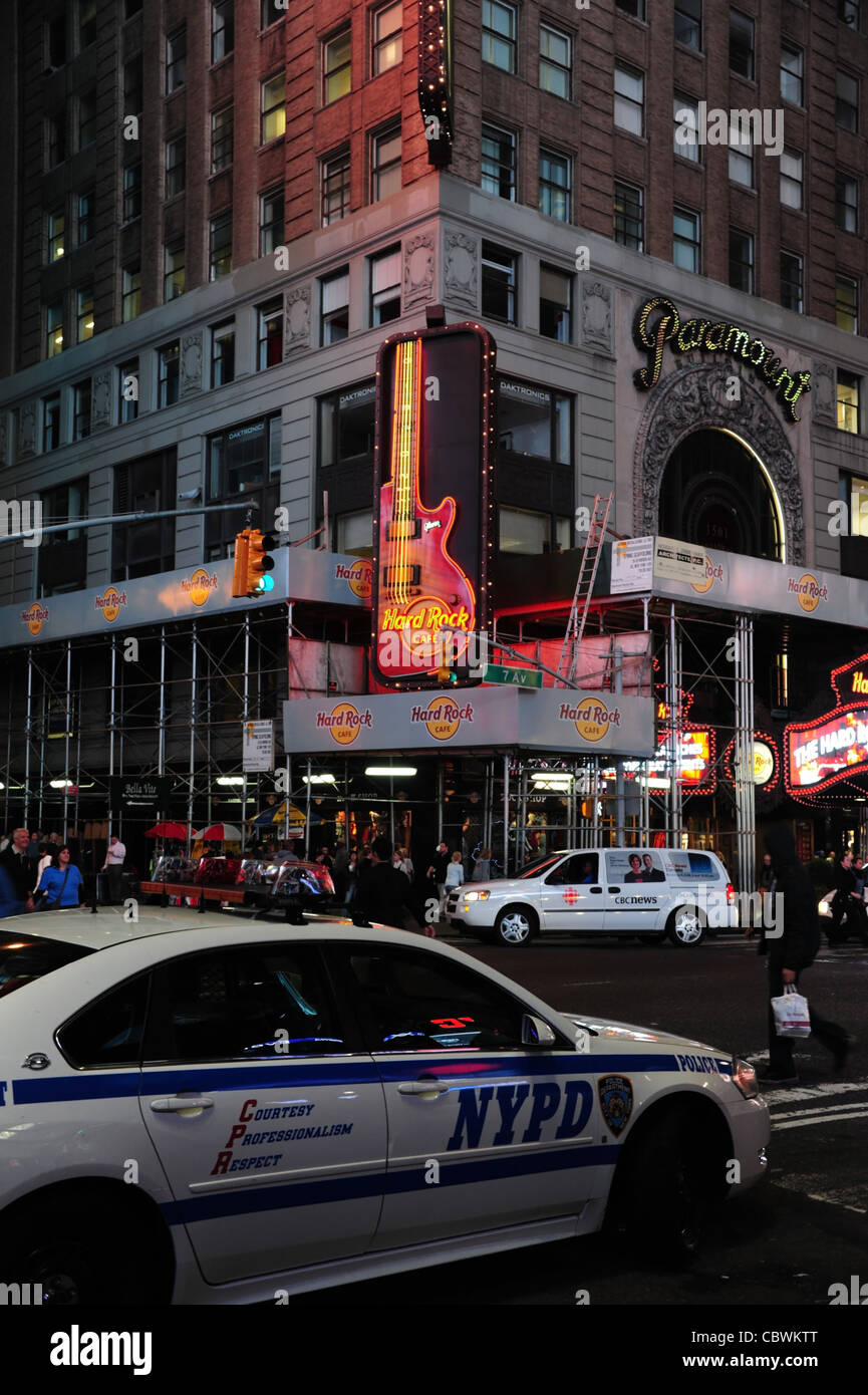 Night shot NYPD police car parked roadside, towards neon guitar Hard ...
