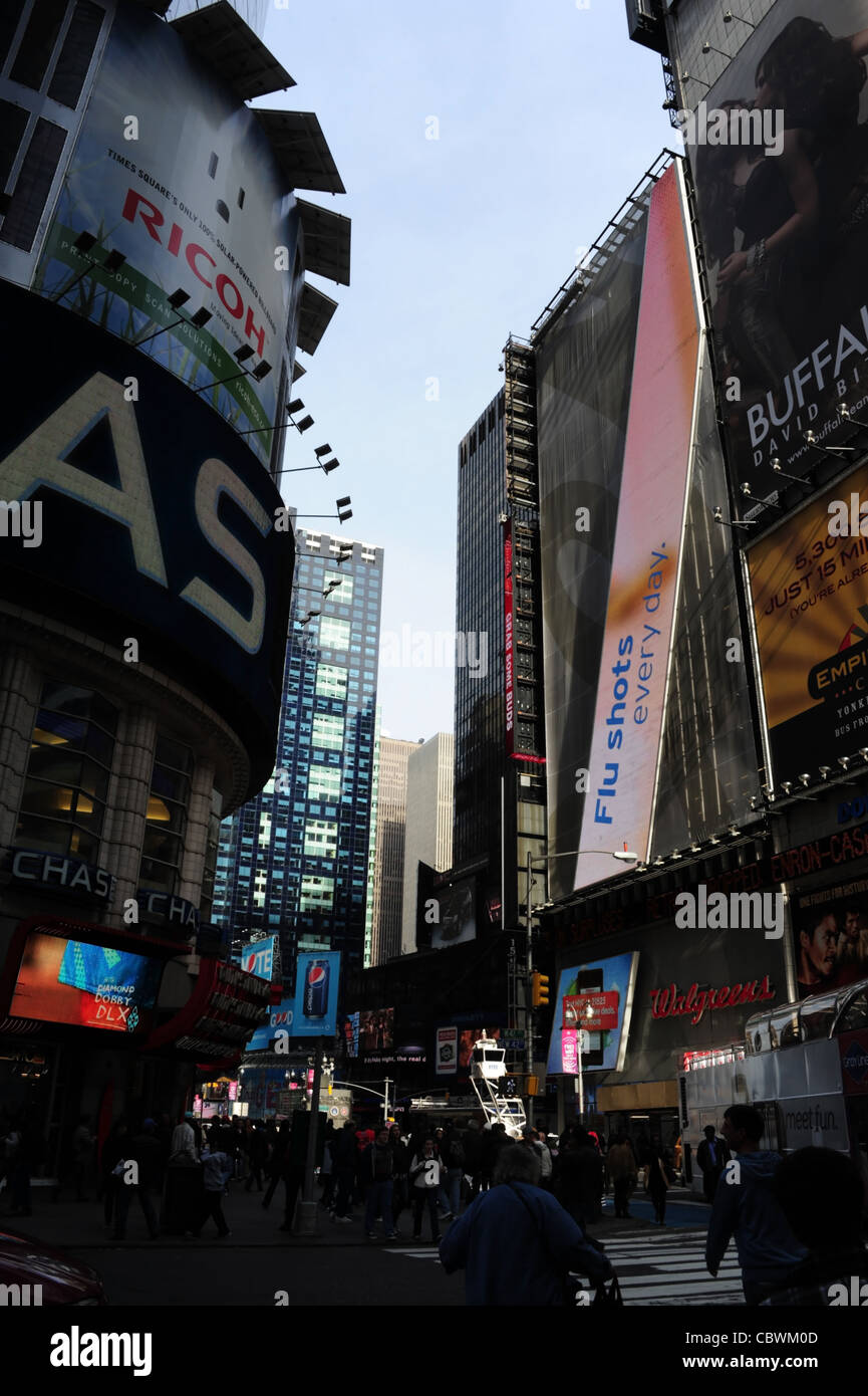 Blue sky shade portrait buildings, billboards, people crossing West ...