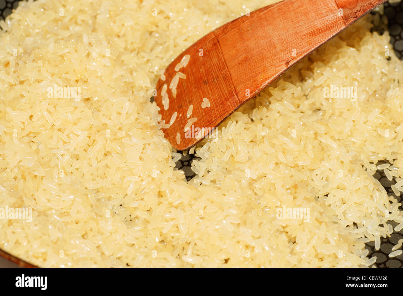 rice on frying pan, skillet, wood spoon Stock Photo - Alamy