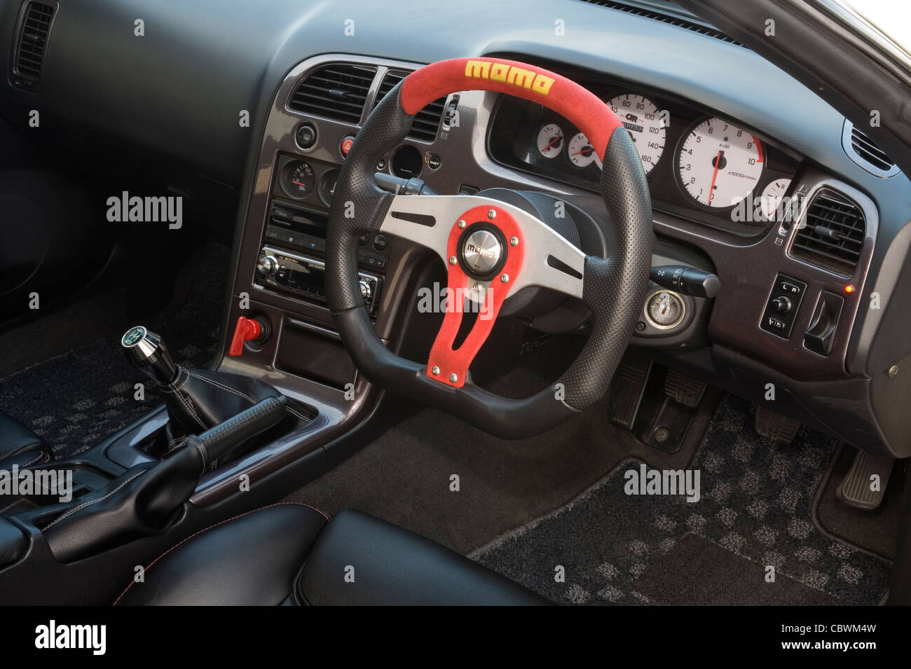 Fancy custom steering wheel and dash dashboard fascia in the cabin of a ...