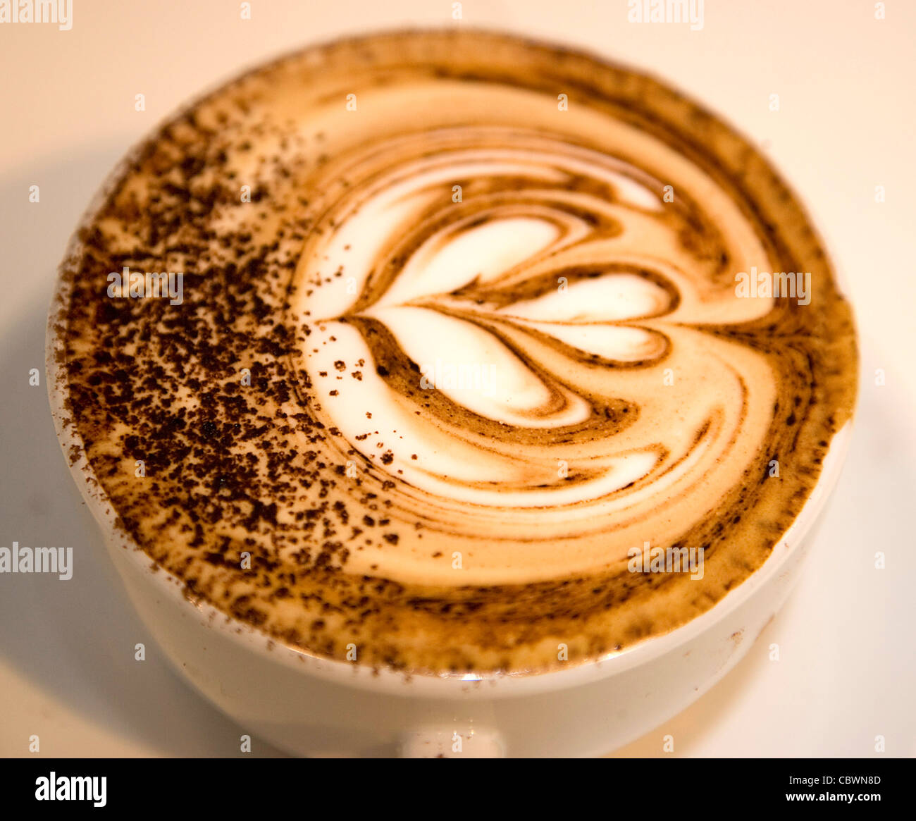 A cup of coffee with a frothy pattern on top Stock Photo - Alamy