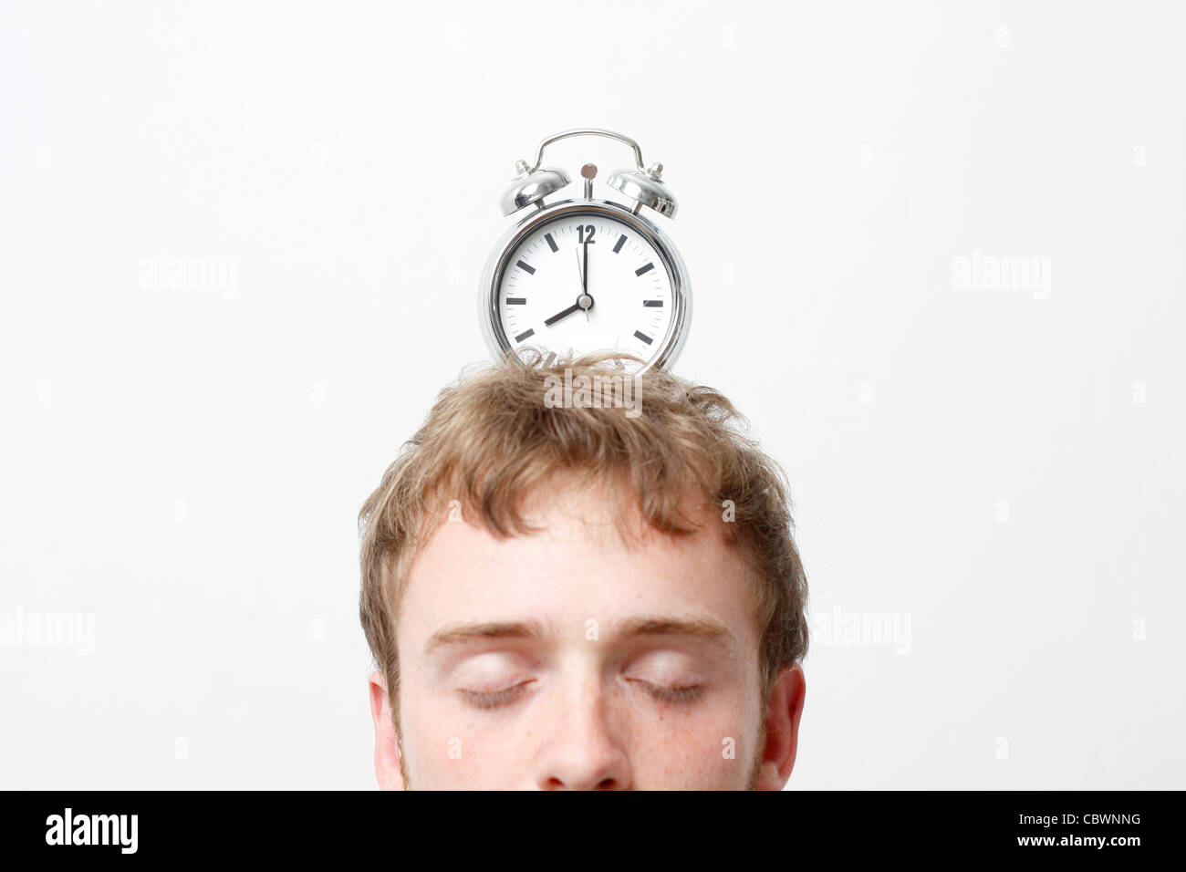 A man with an alarm clock on top of his head Stock Photo - Alamy