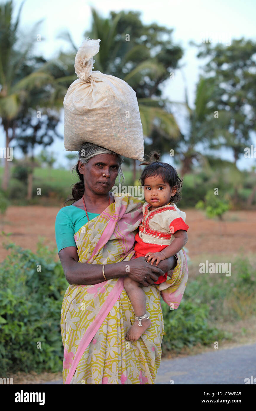 Rural old woman carrying a little girl Andhra Pradesh South India Stock ...
