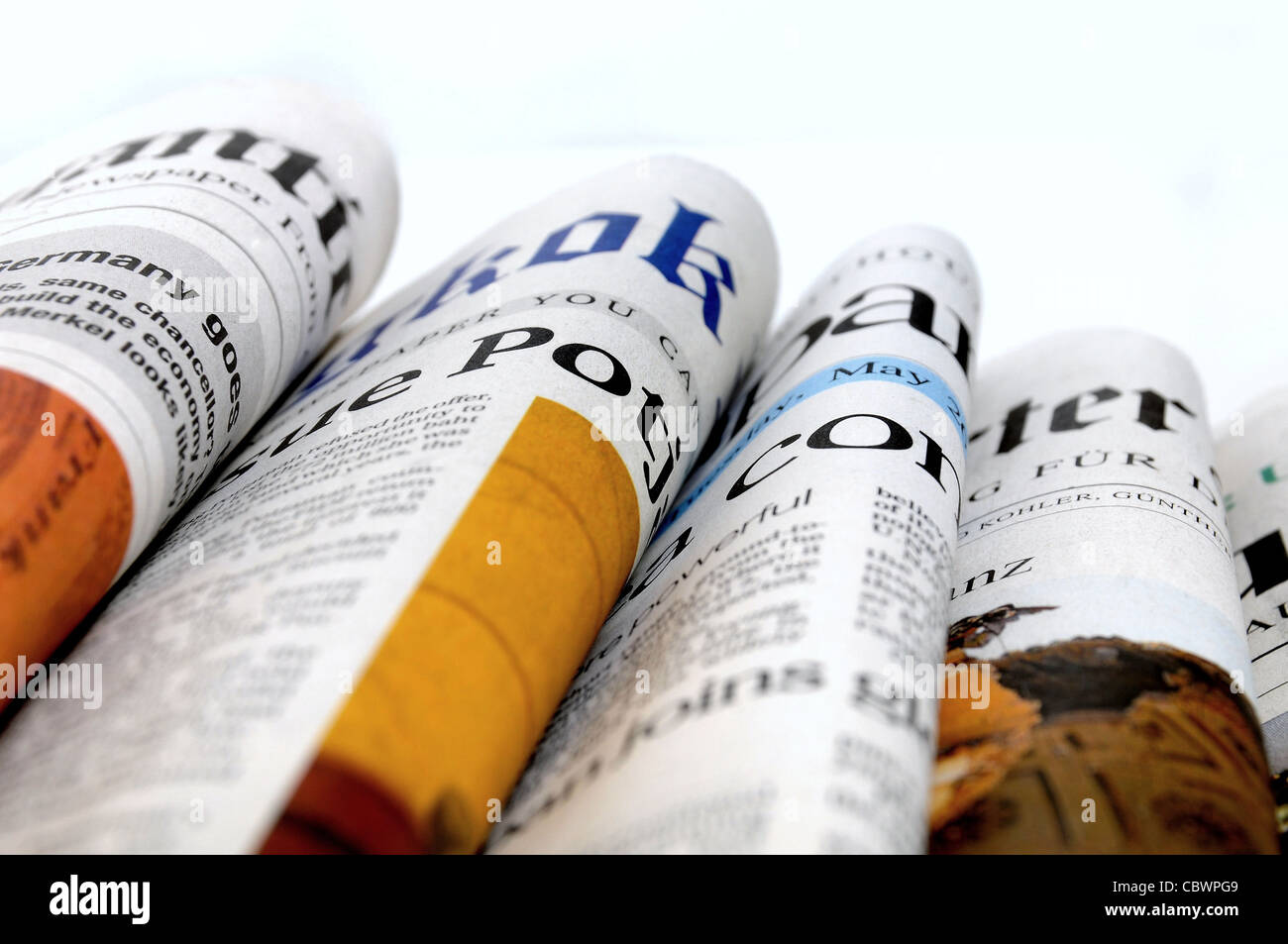 Various international newspapers on white background Stock Photo - Alamy