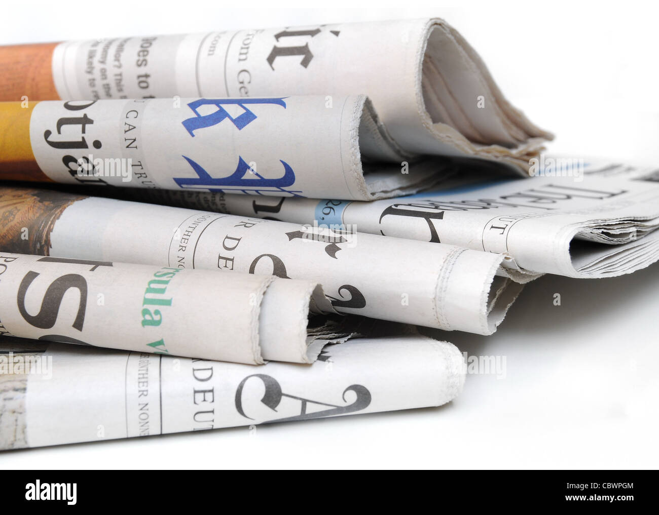 Various international newspapers on white background Stock Photo - Alamy