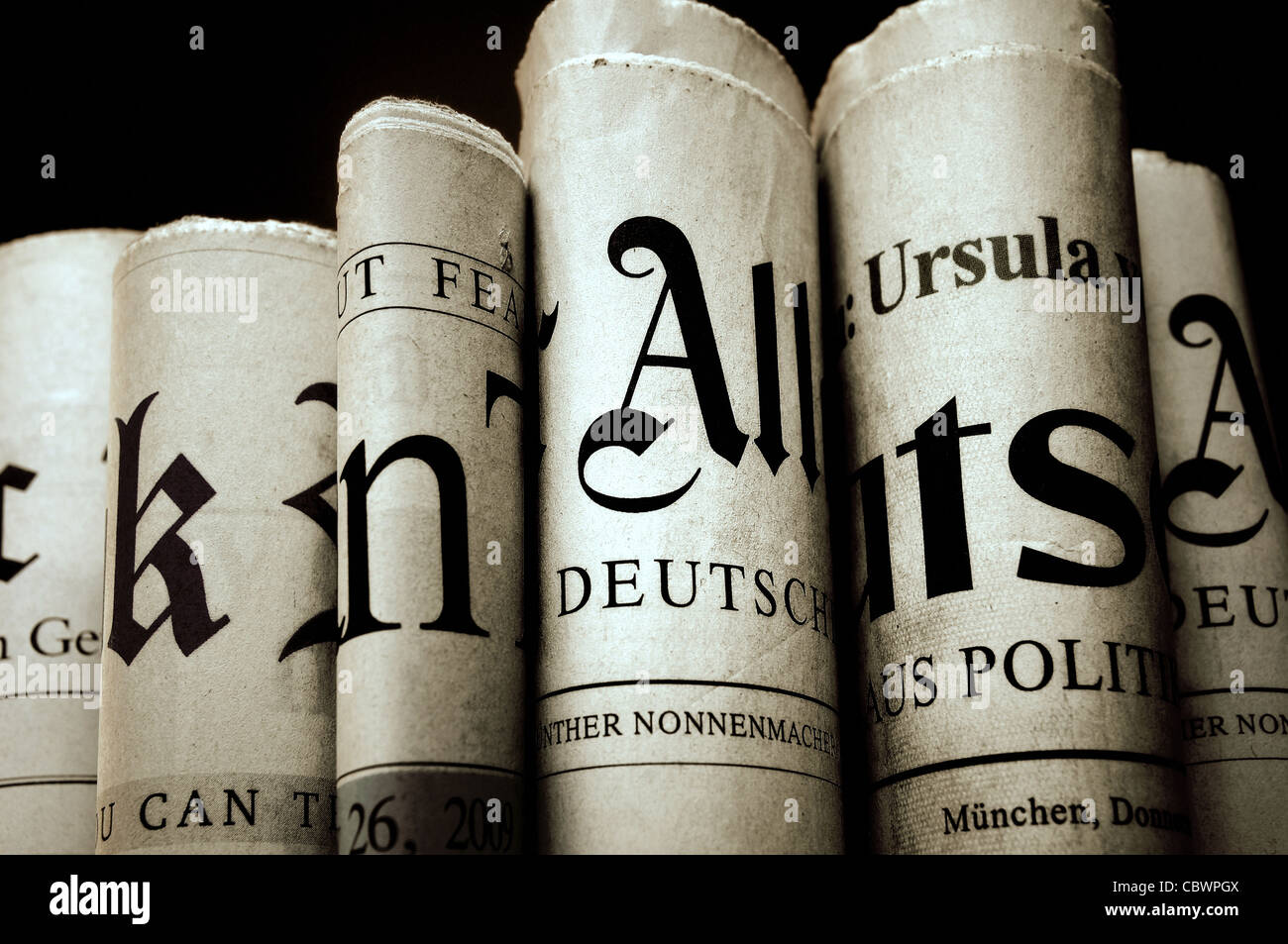 Various international newspapers on black background Stock Photo - Alamy