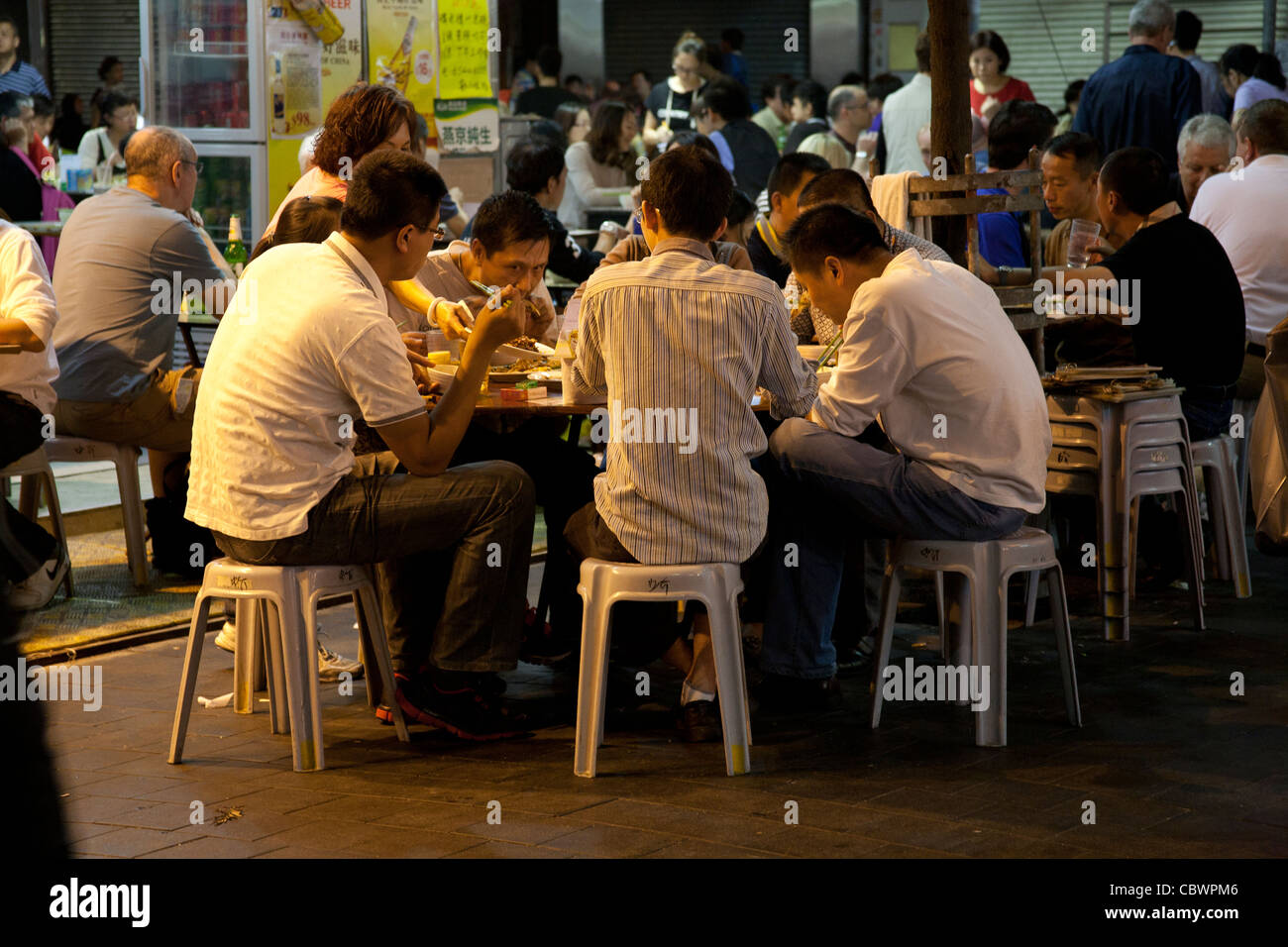 People eating at outside tables at night in the street cafes of Temple ...