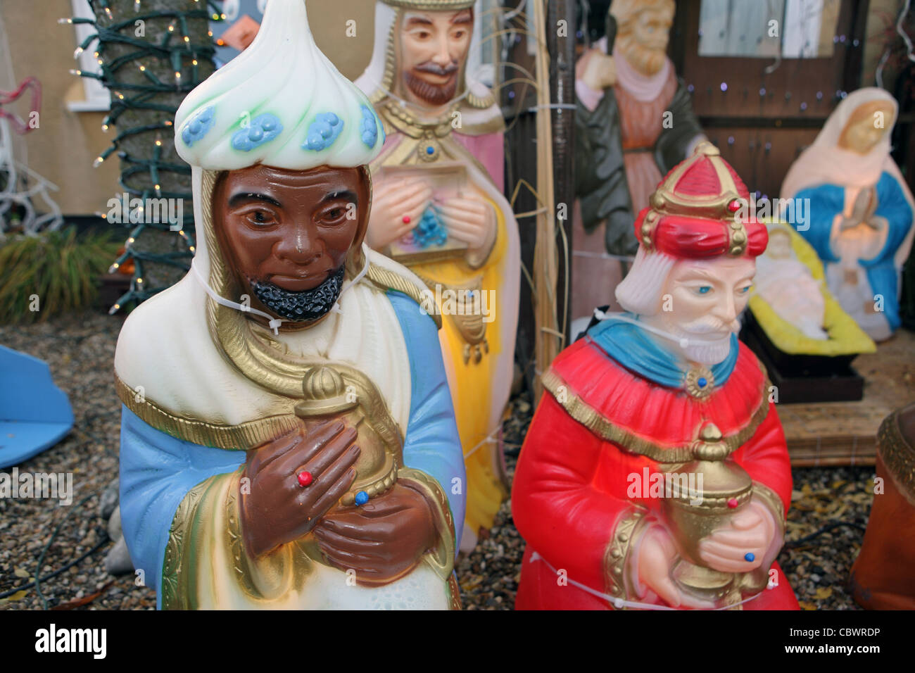 brightly colored plastic Christmas decorations in garden of UK house ...