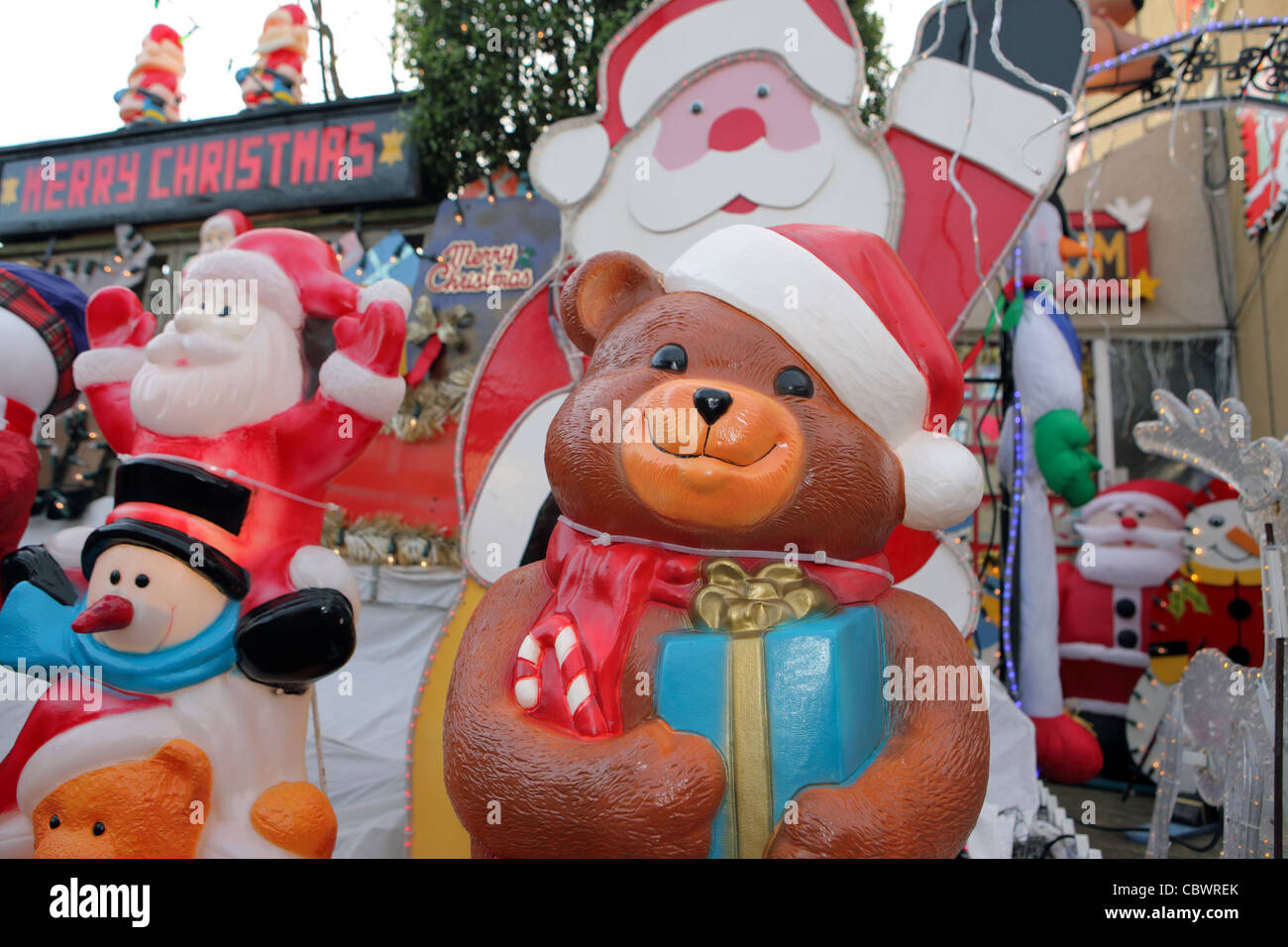 brightly colored plastic Christmas decorations in garden of UK house ...