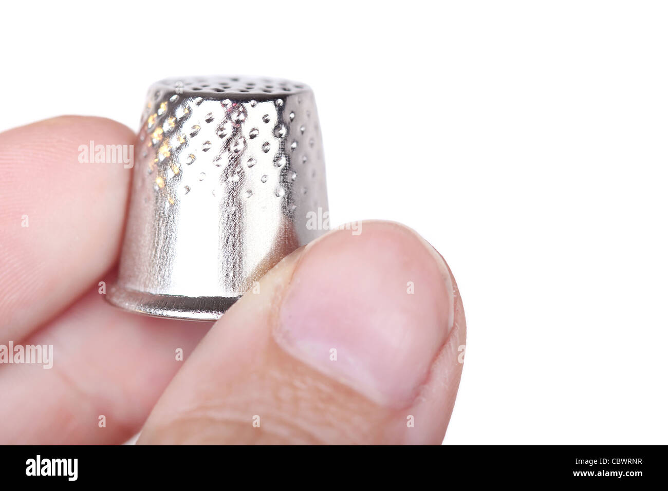Thimble in hand, closeup on white Stock Photo - Alamy