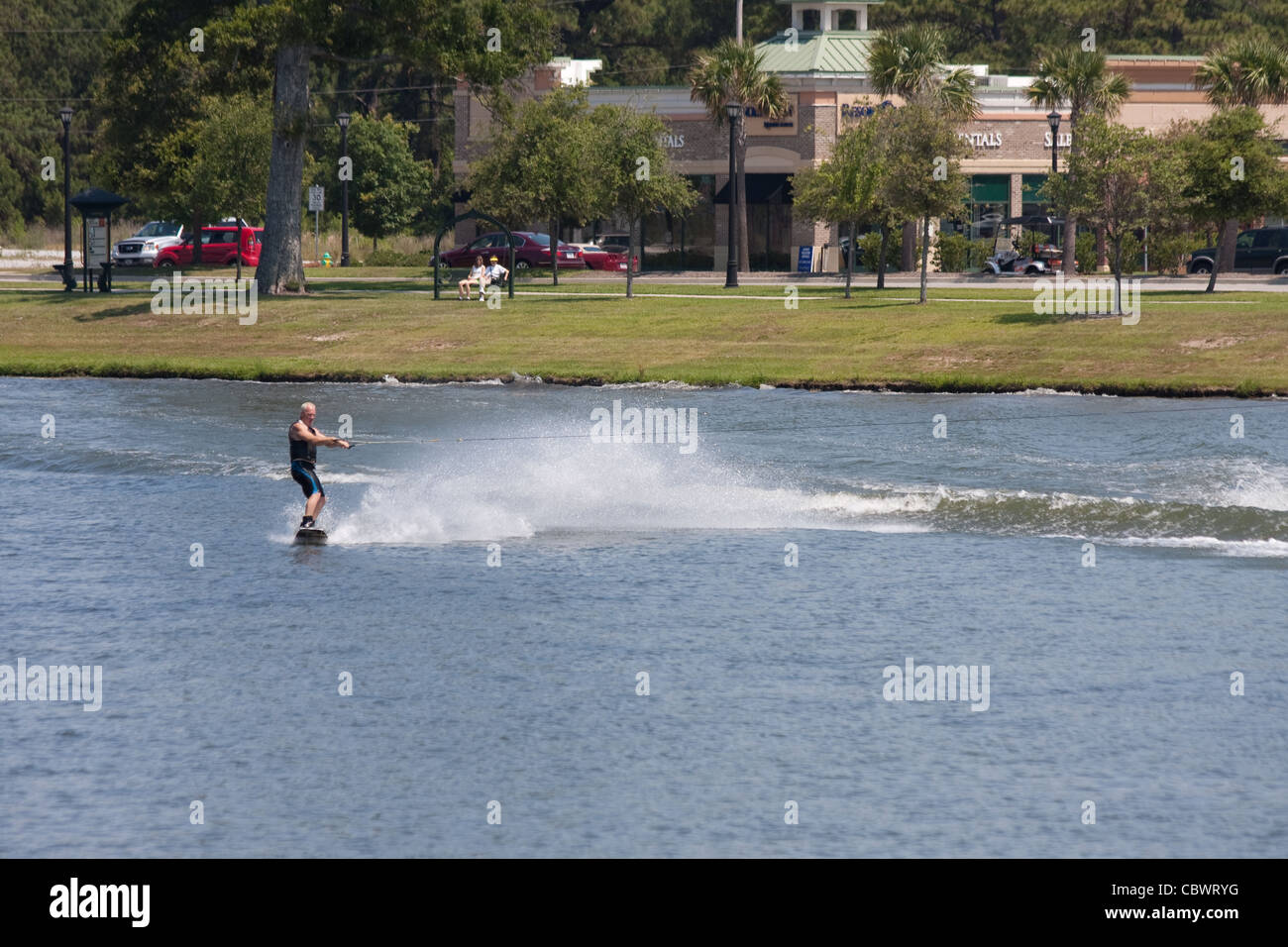 Man jumping the wake, stunts on a wakeboard, extreme sport Stock Photo ...