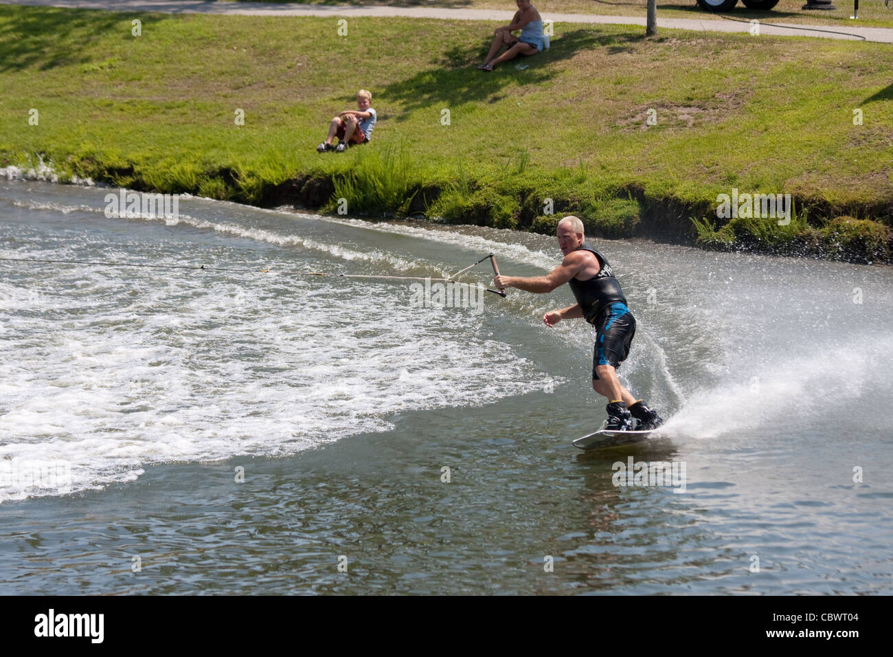 Man jumping the wake, stunts on a wakeboard, extreme sport Stock Photo ...