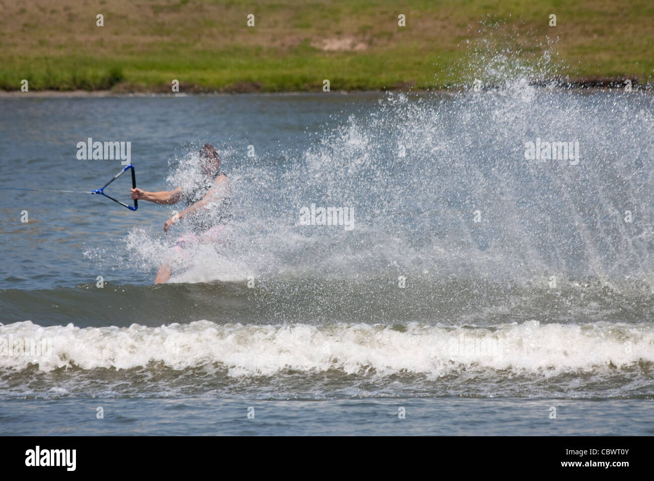 Man jumping the wake, stunts on a wakeboard, extreme sport Stock Photo ...