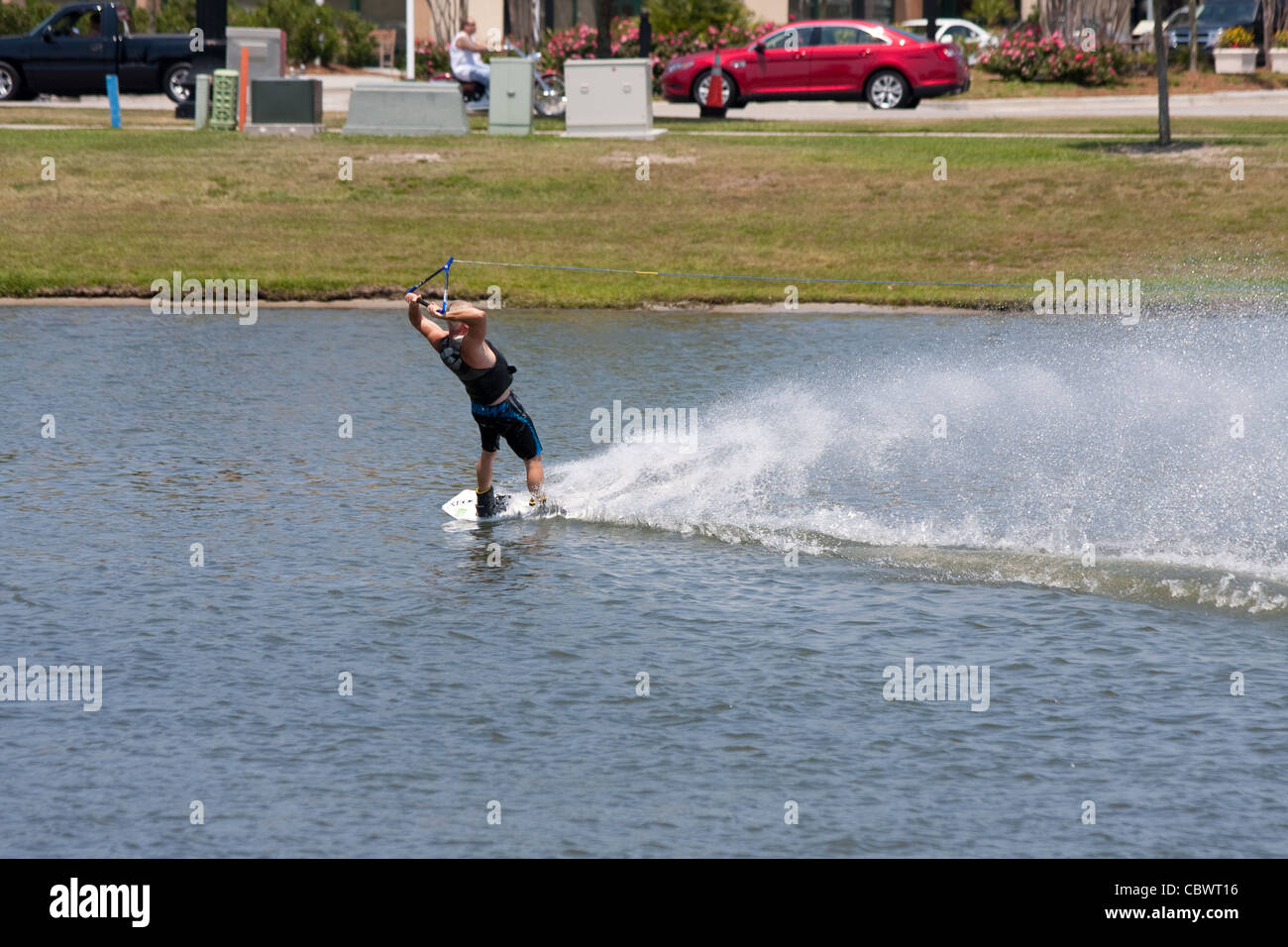 Man jumping the wake, stunts on a wakeboard, extreme sport Stock Photo ...